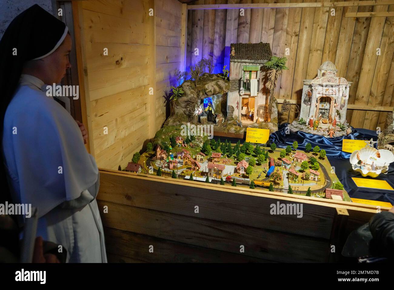 A nun admires nativity scenes part of the exhibition "100 Presepi", 100 ...