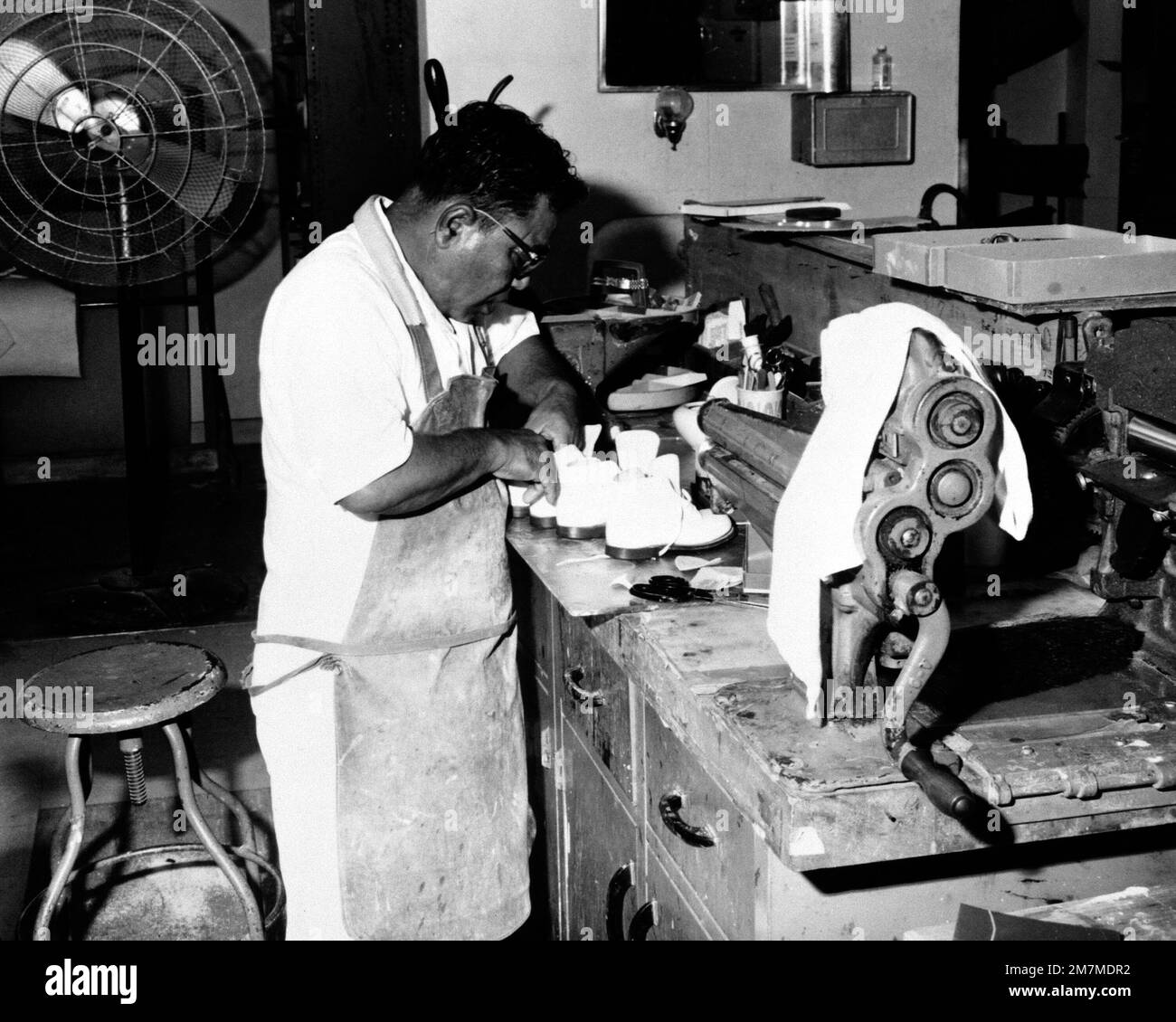 An orthopedics specialist places scaphoid arch pads in the shoes of an ...