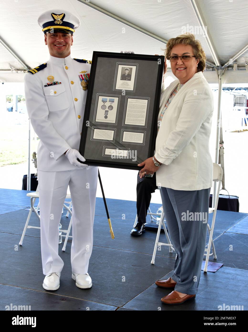 Cecilla Guillot presents Lt. Eli Maurer with a gift during the ...