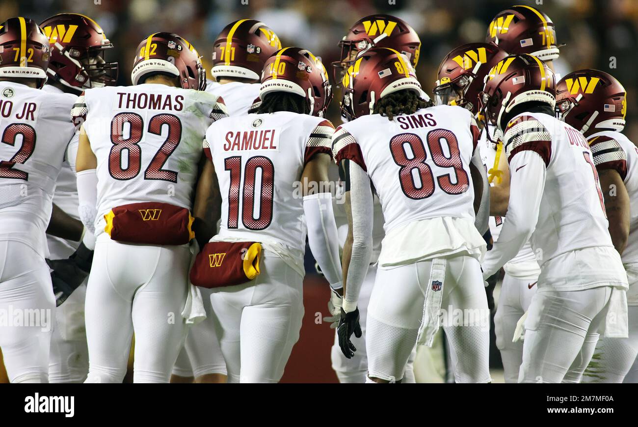Washington Commanders players huddle up during an NFL football game ...