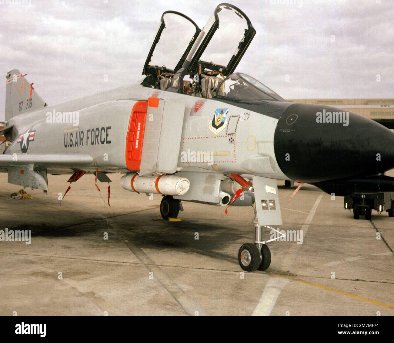 A right front view of an F-4C Phantom II aircraft loaded with a camera ...