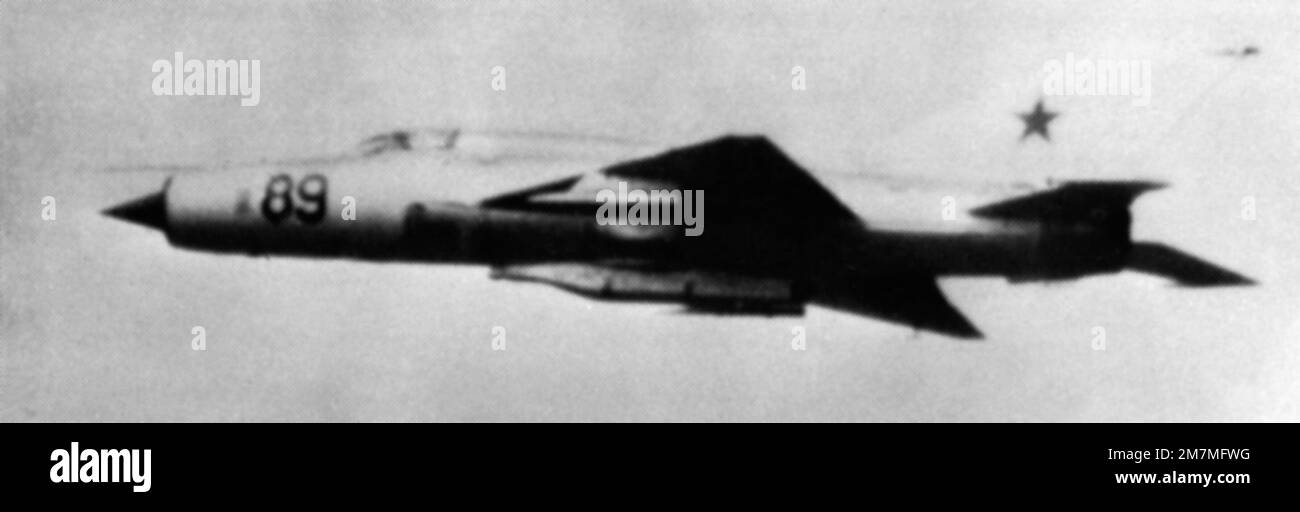 A left side view of a Soviet MiG-21 Fishbed fighter aircraft in flight ...