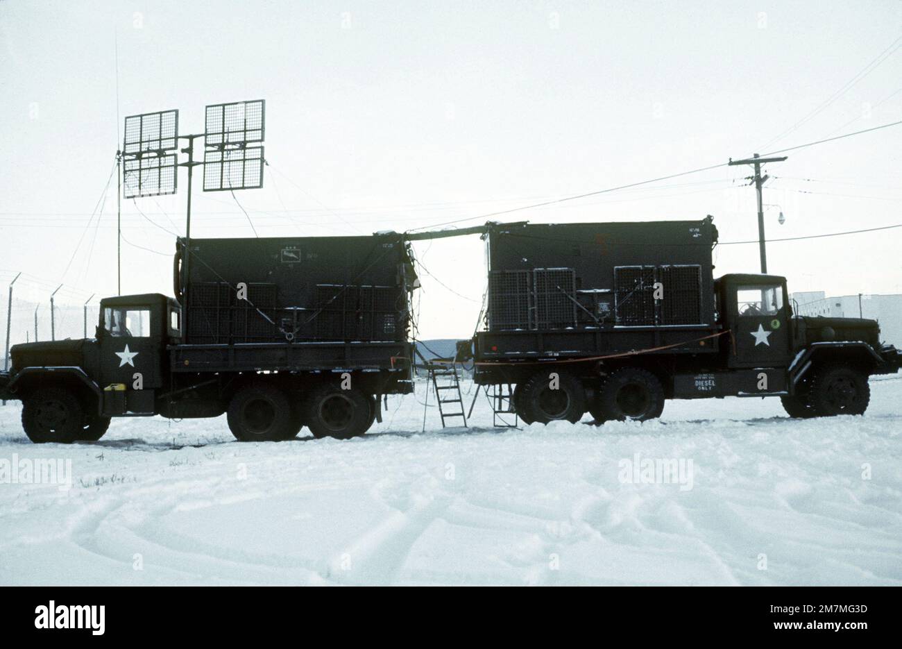A view of two truck-mounted shelters housing MRC-69 radio terminal sets ...