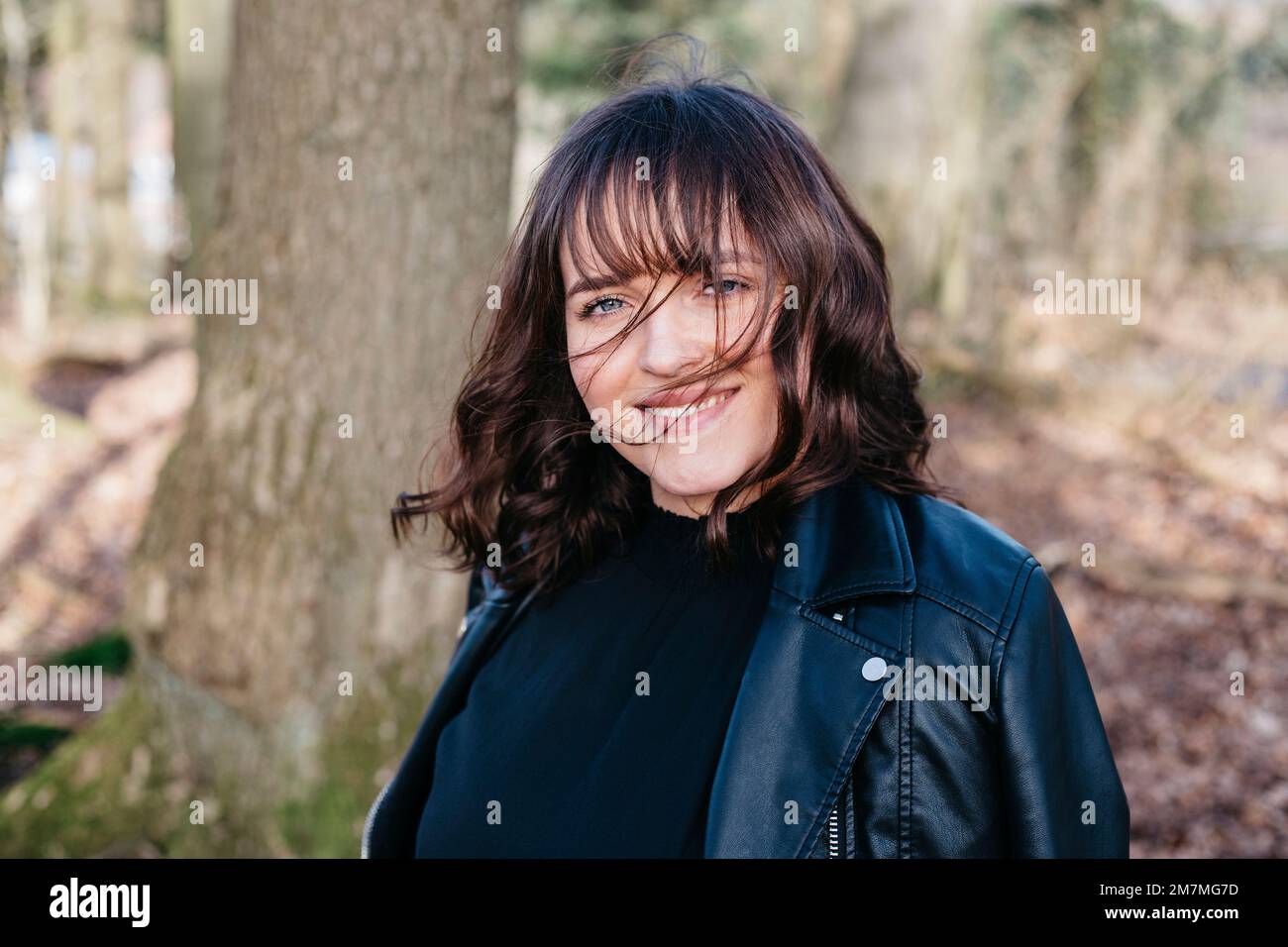 Happy laughing woman in forest Stock Photo - Alamy