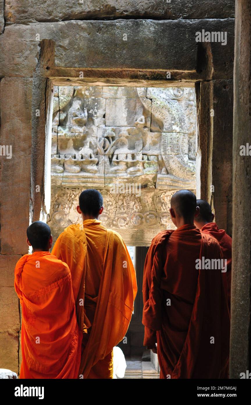 Young Buddhist monks marvelled at the stone faces of Bayon temple ...