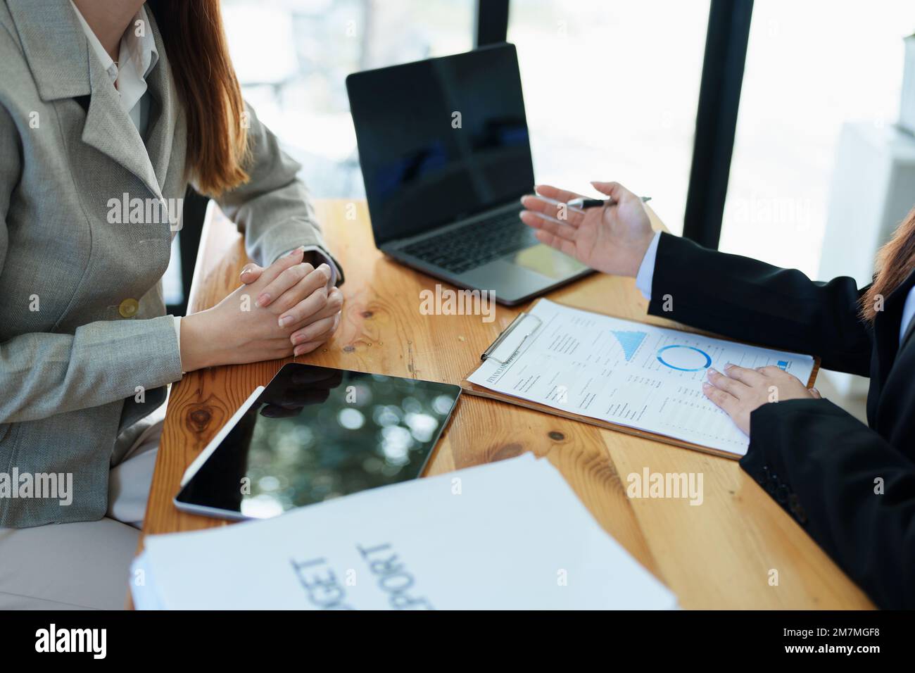 Financial analysts analyzing business reports on planned investment ...