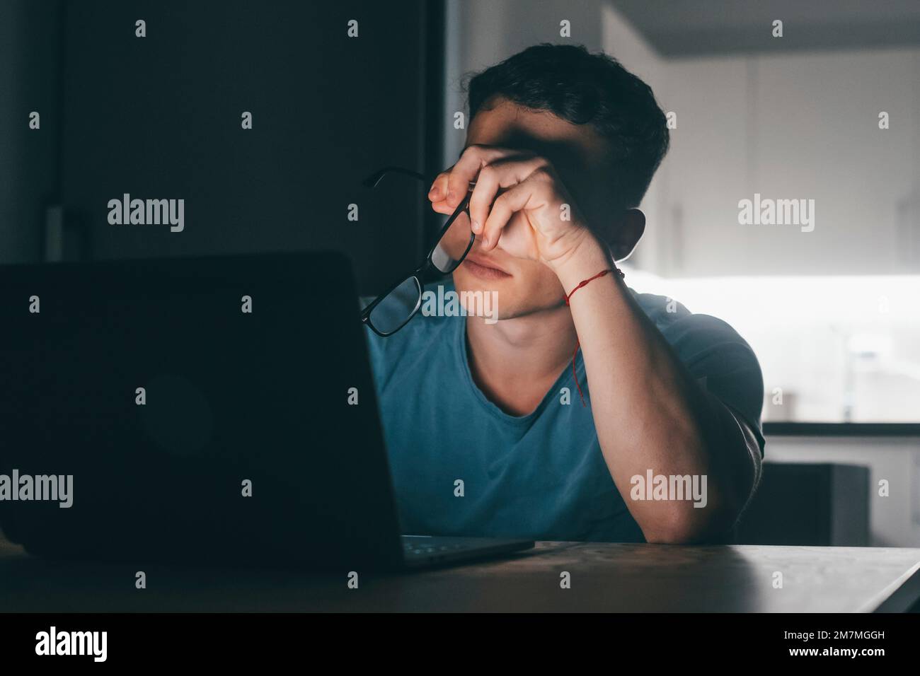 One young sick and tired man feeling bad touching his eyes and face at ...