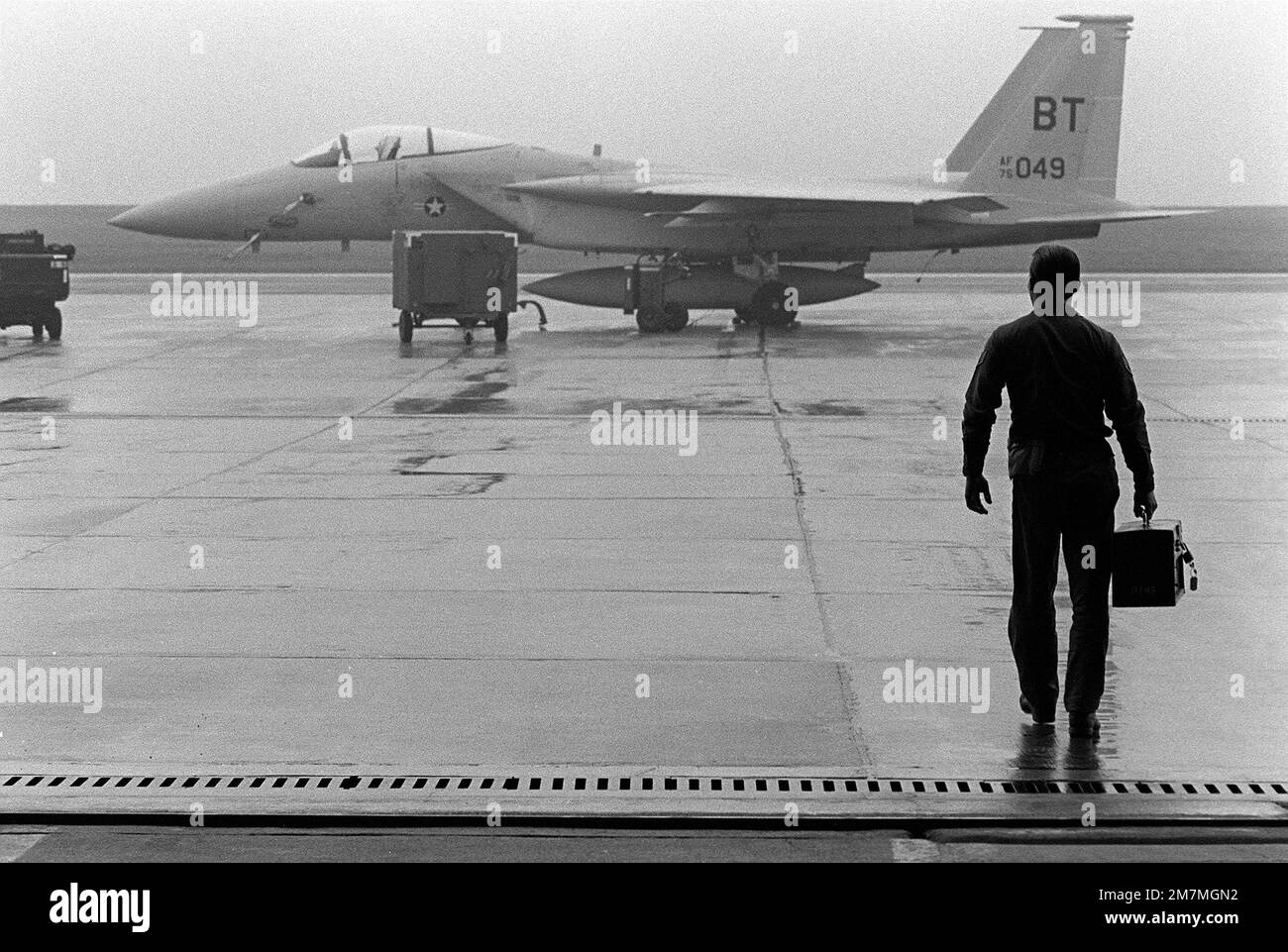 SSGT David A. Danner, an F-15 Eagle aircraft crew chief, walks toward ...