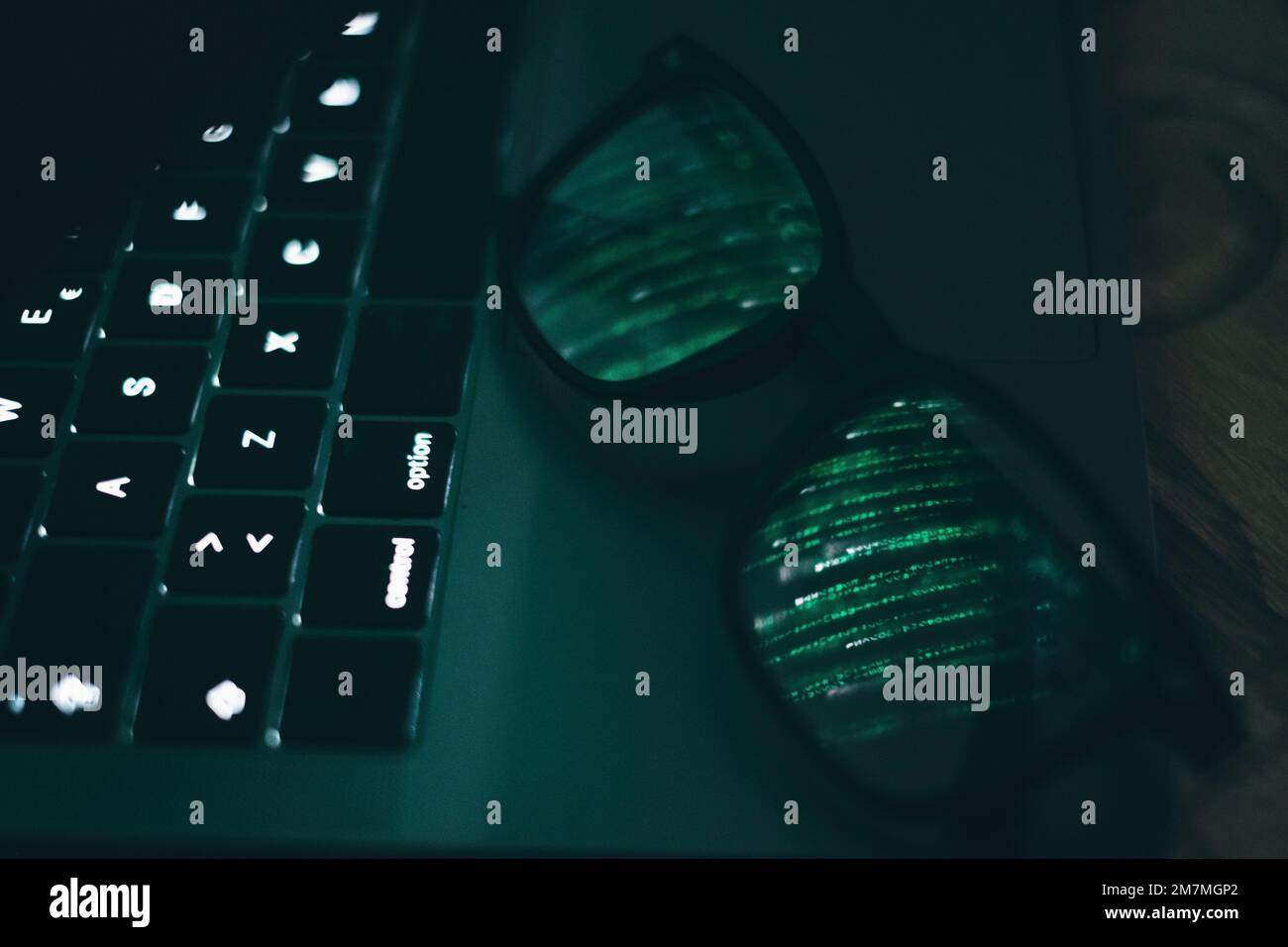 Portrait and close up of glasses on laptop with the light of screen ...