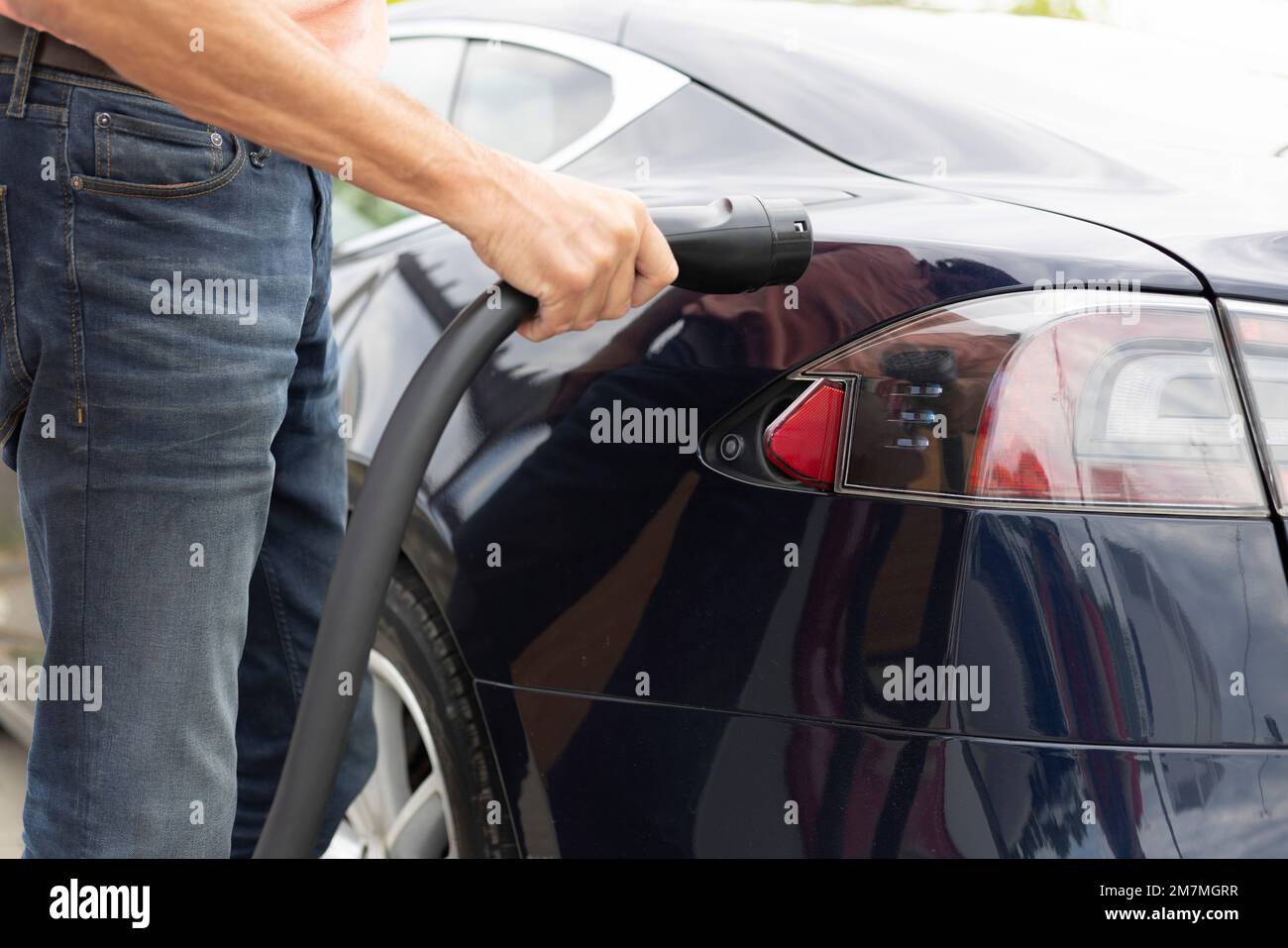 Person charging tesla model supercharger hi-res stock photography and ...