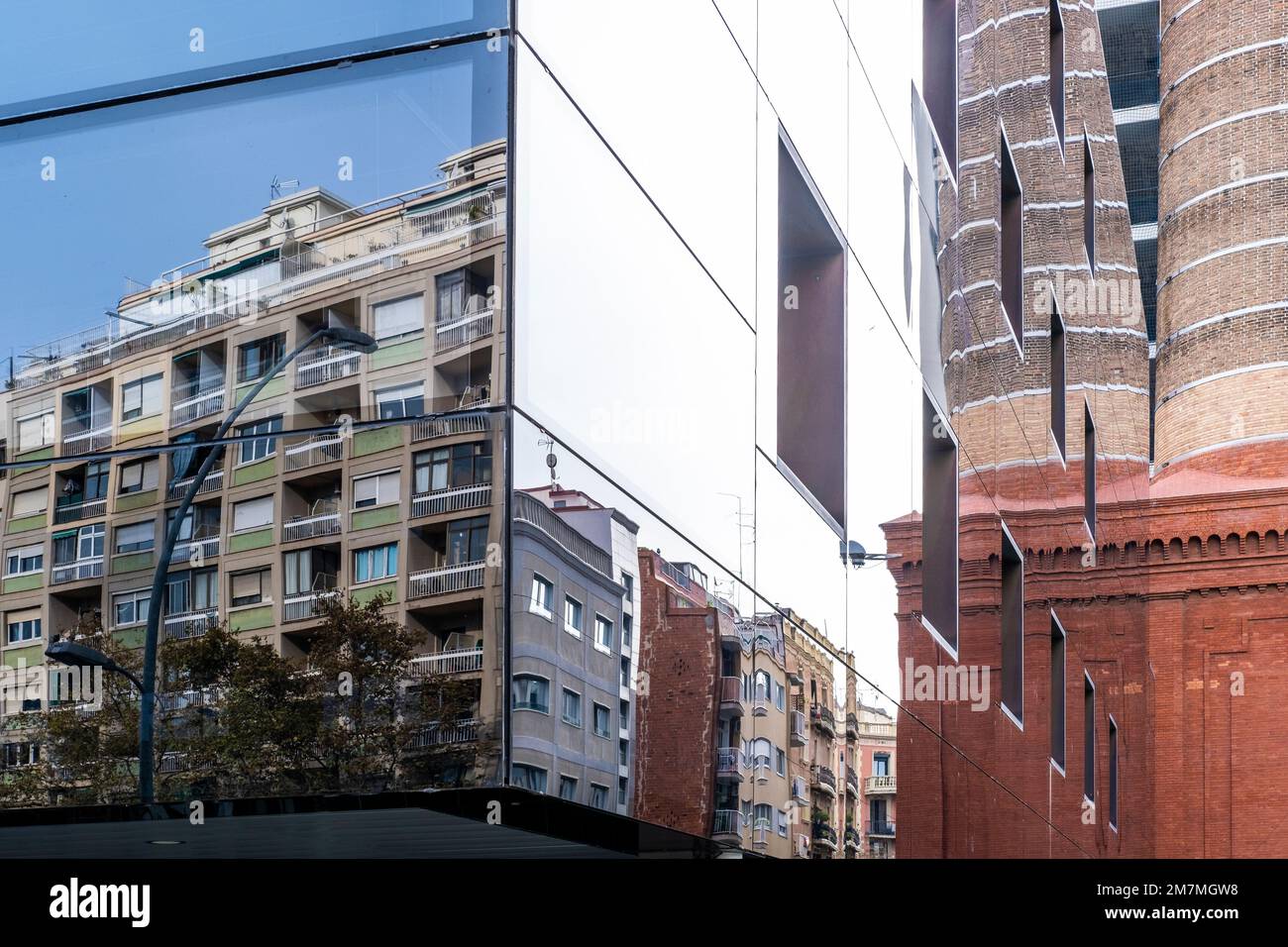 apartment buildings reflected in a building with a mirrored facade ...