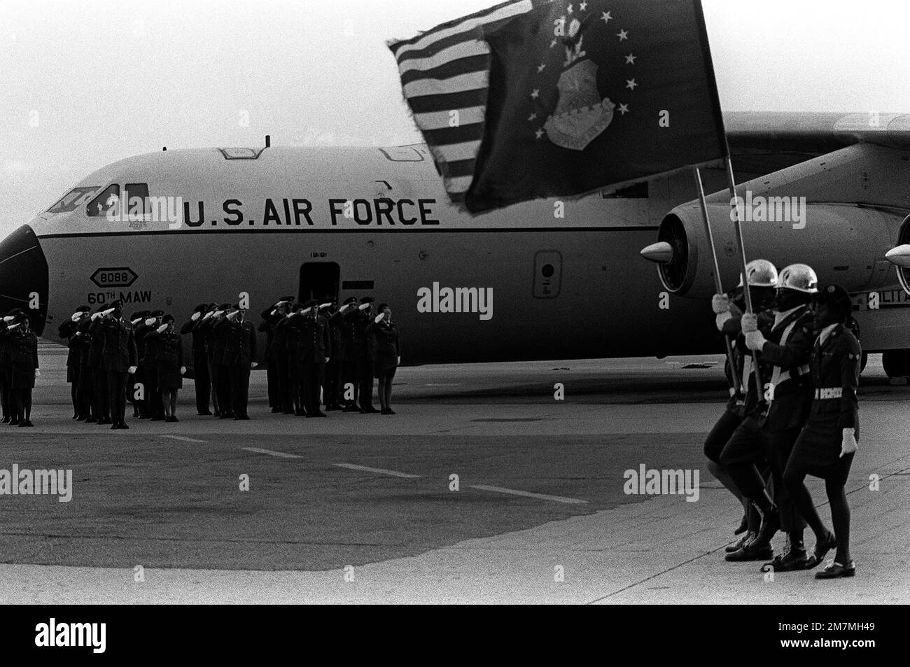 An Air Force honor guard salutes the flags as they are paraded ...