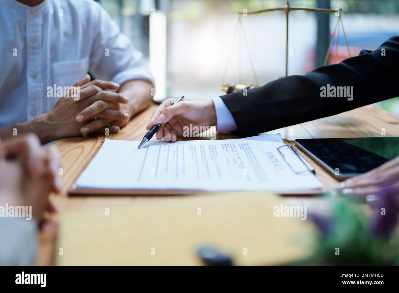 Lawyer hands important documents to couple to sign Stock Photo - Alamy