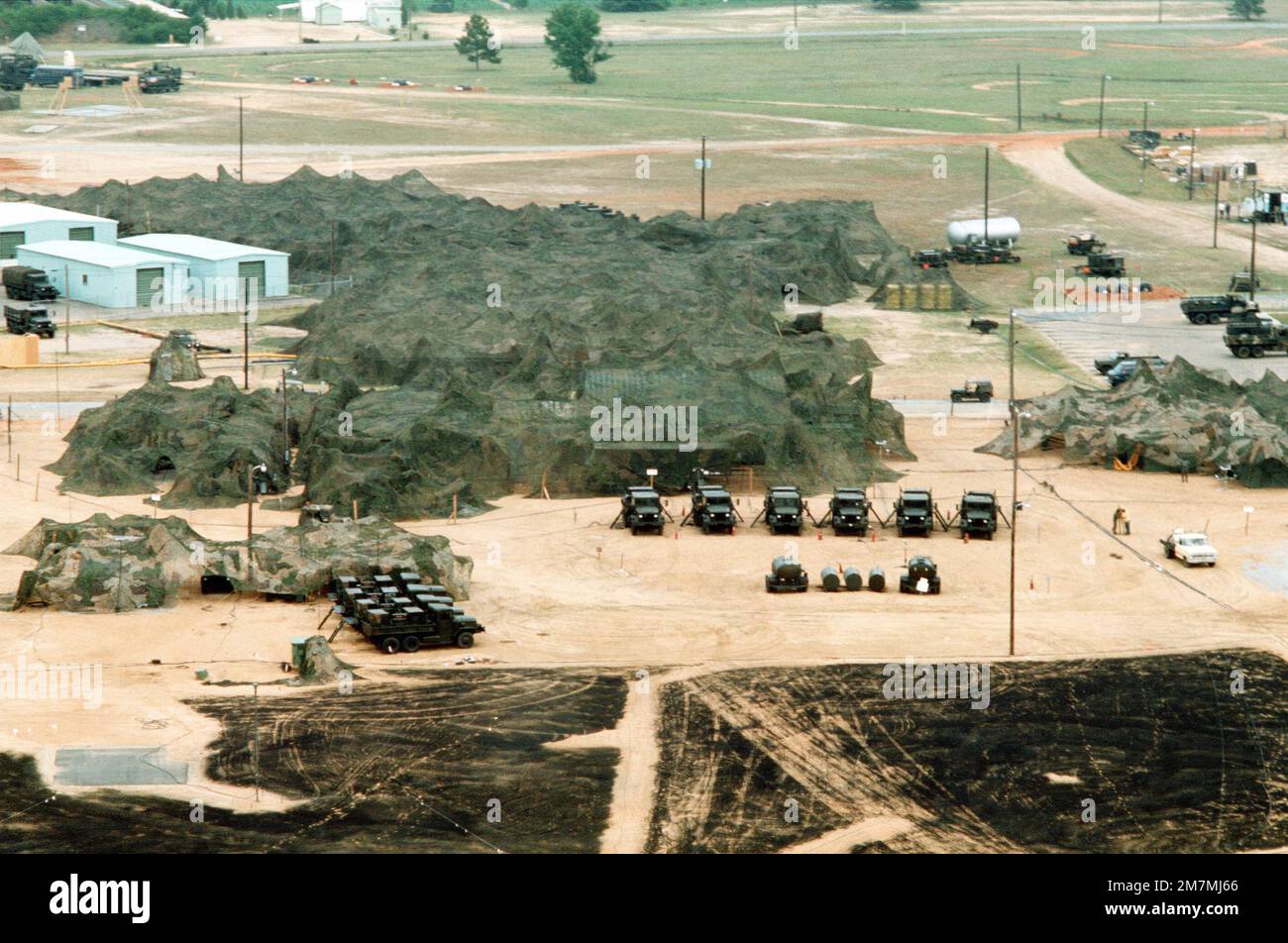 An aerial view of a camouflaged tent complex in use during joint ...