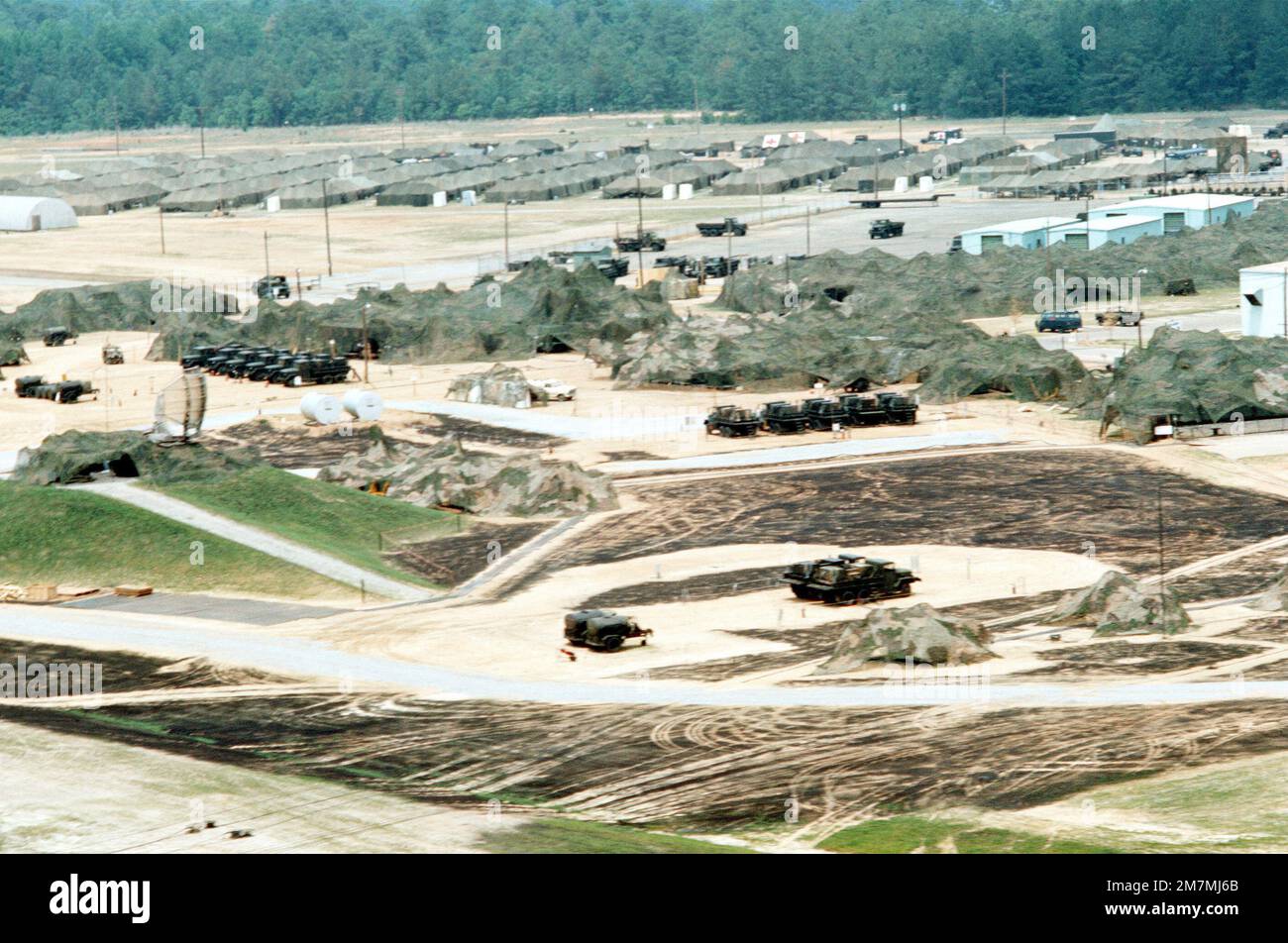 An aerial view of the tent city and camouflaged installations in use ...