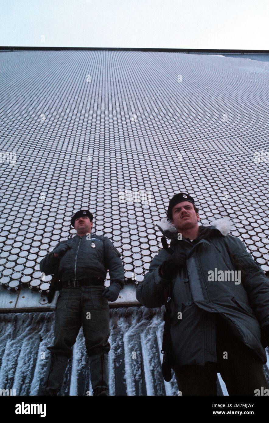 Security policemen stand guard in front of the COBRA DANE phased-array ...