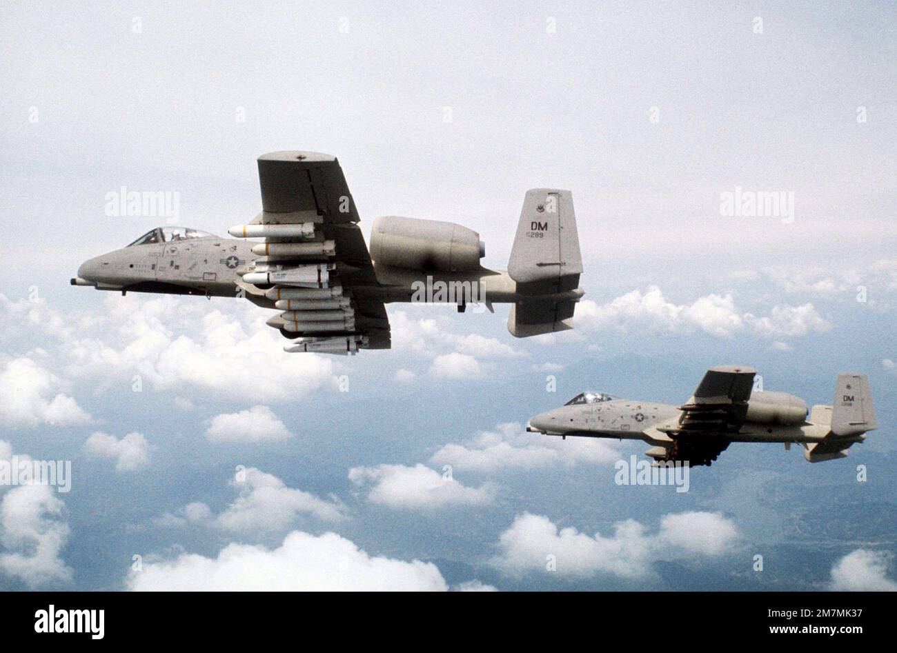 An air-to-air left underside view of two A-10 Thunderbolt II aircraft ...