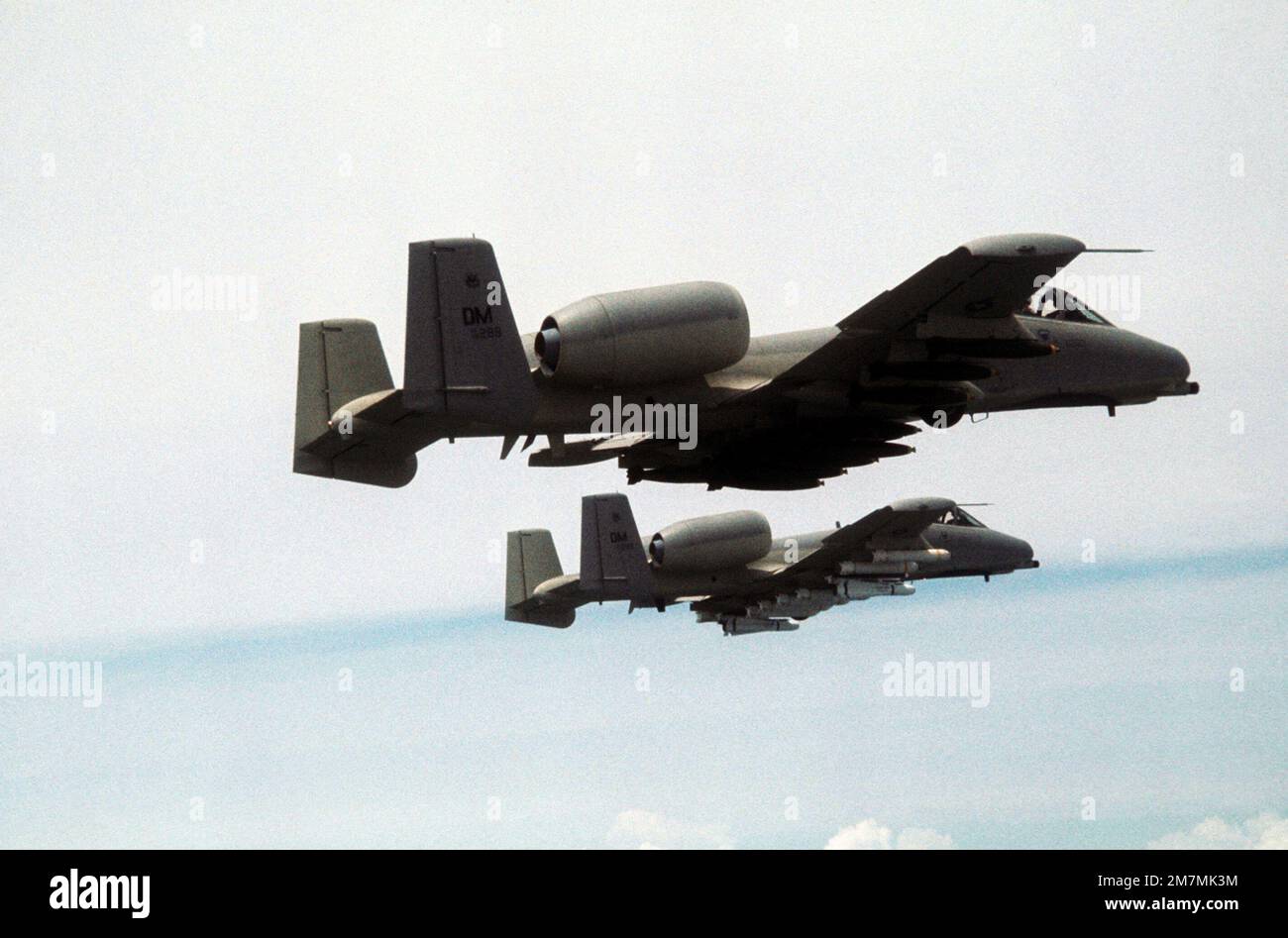 An air-to-air right underside view of two A-10 Thunderbolt II aircraft ...