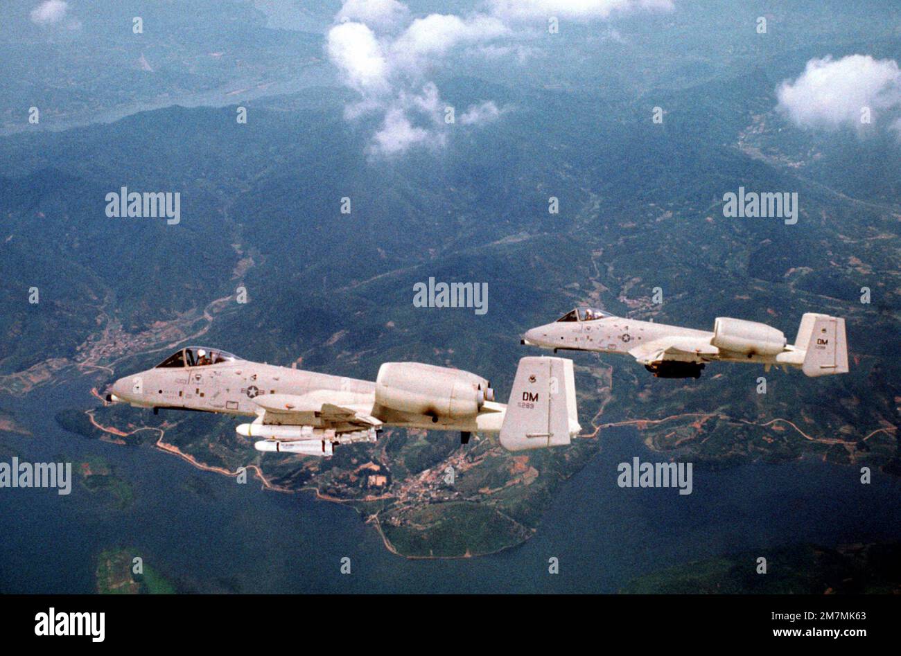 An air-to-air left side view of two A-10 Thunderbolt II aircraft. The A ...
