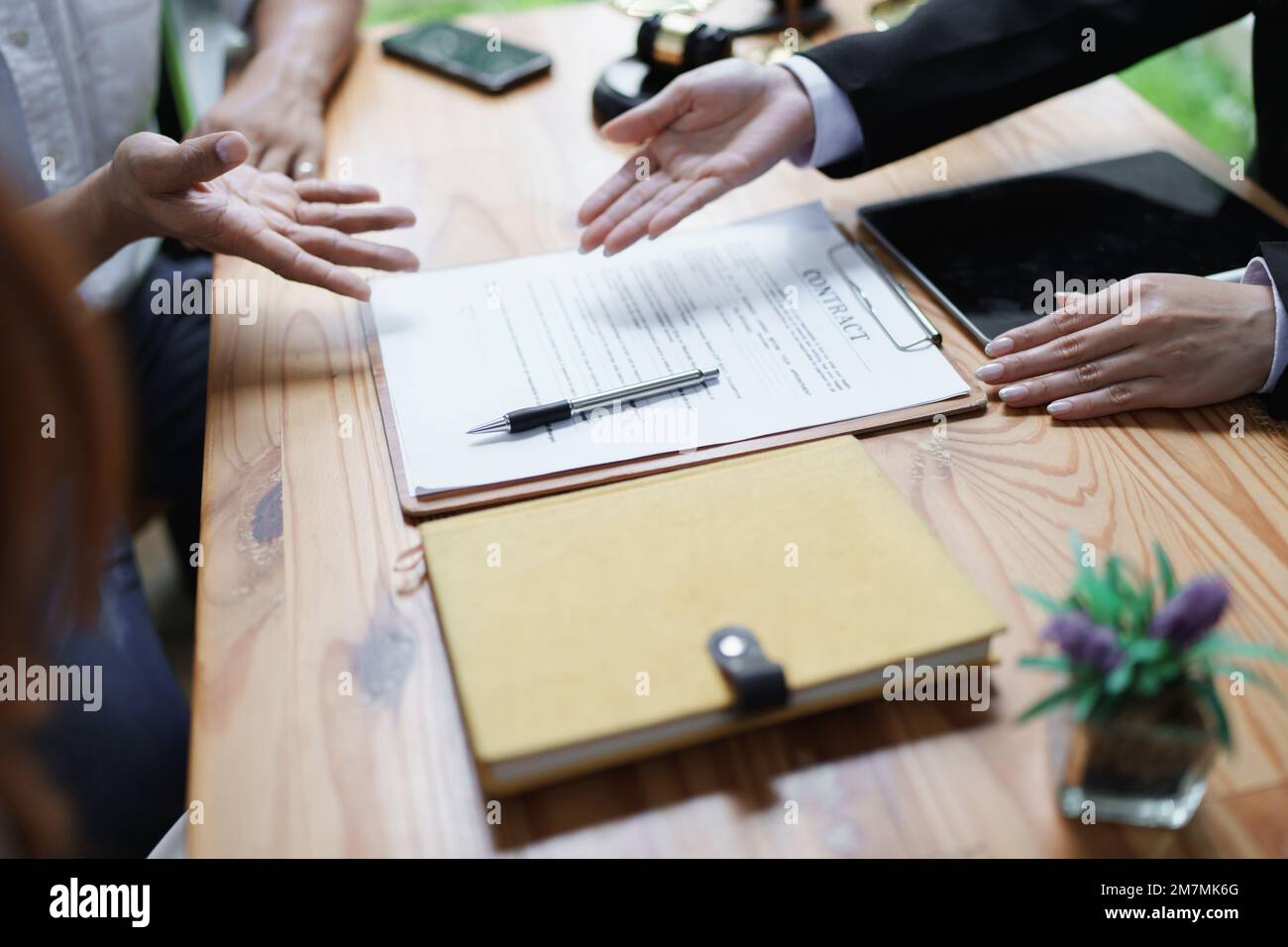 Lawyer hands important documents to couple to sign Stock Photo - Alamy