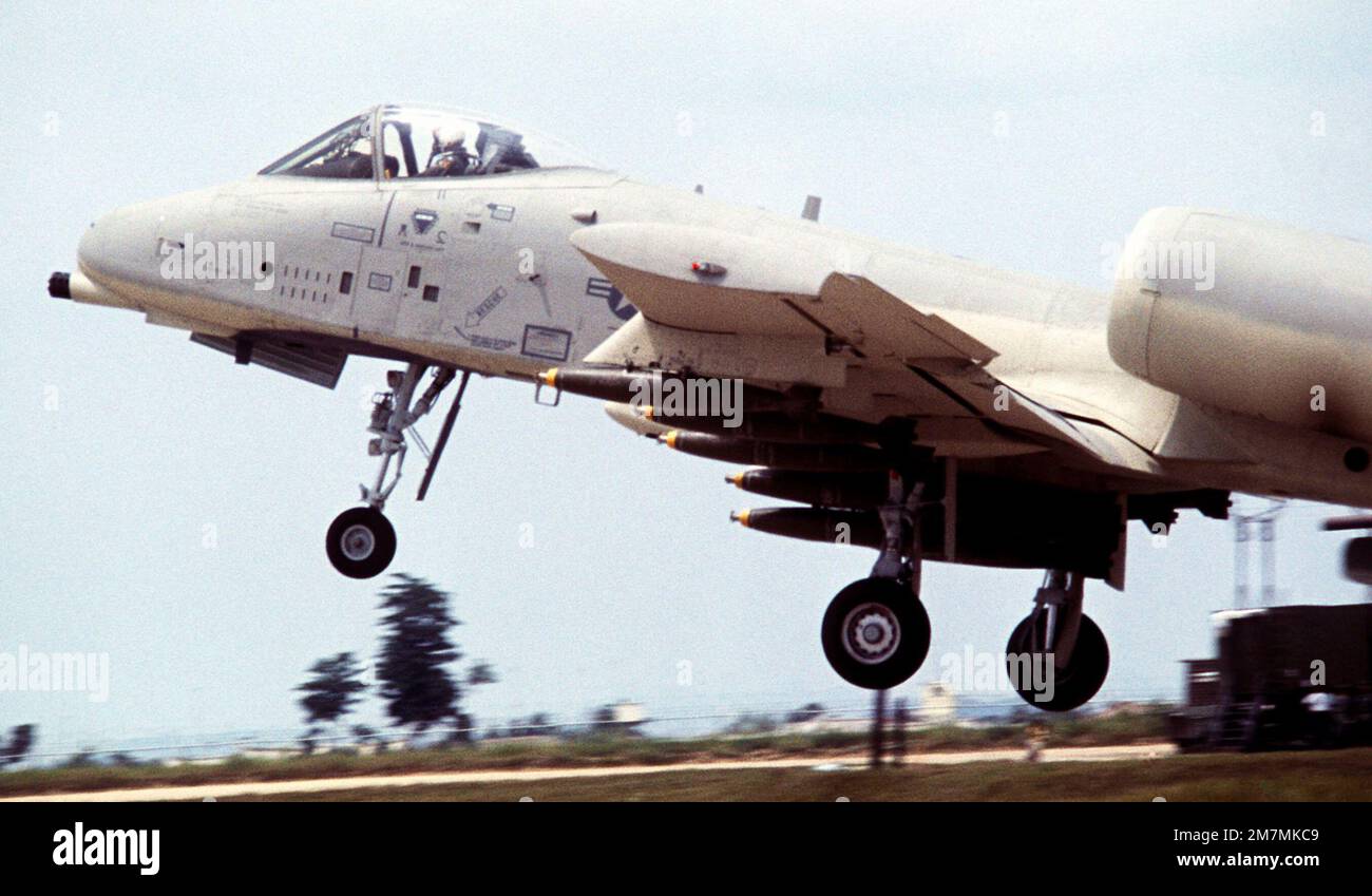 A left side view of an A-10 Thunderbolt II aircraft taking off with a ...