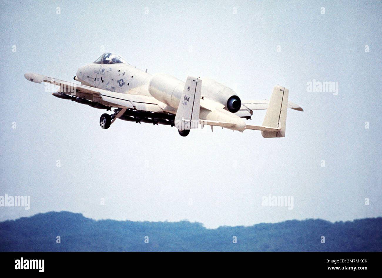 A left rear view of an A-10 Thunderbolt II aircraft taking off with a ...
