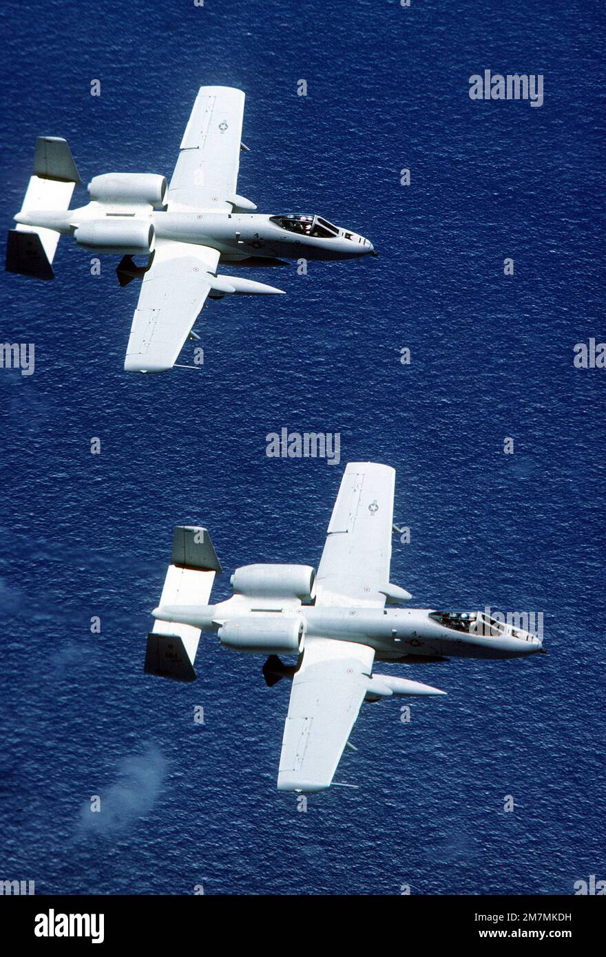 An air-to-air right topside view of two A-10 Thunderbolt II aircraft in ...