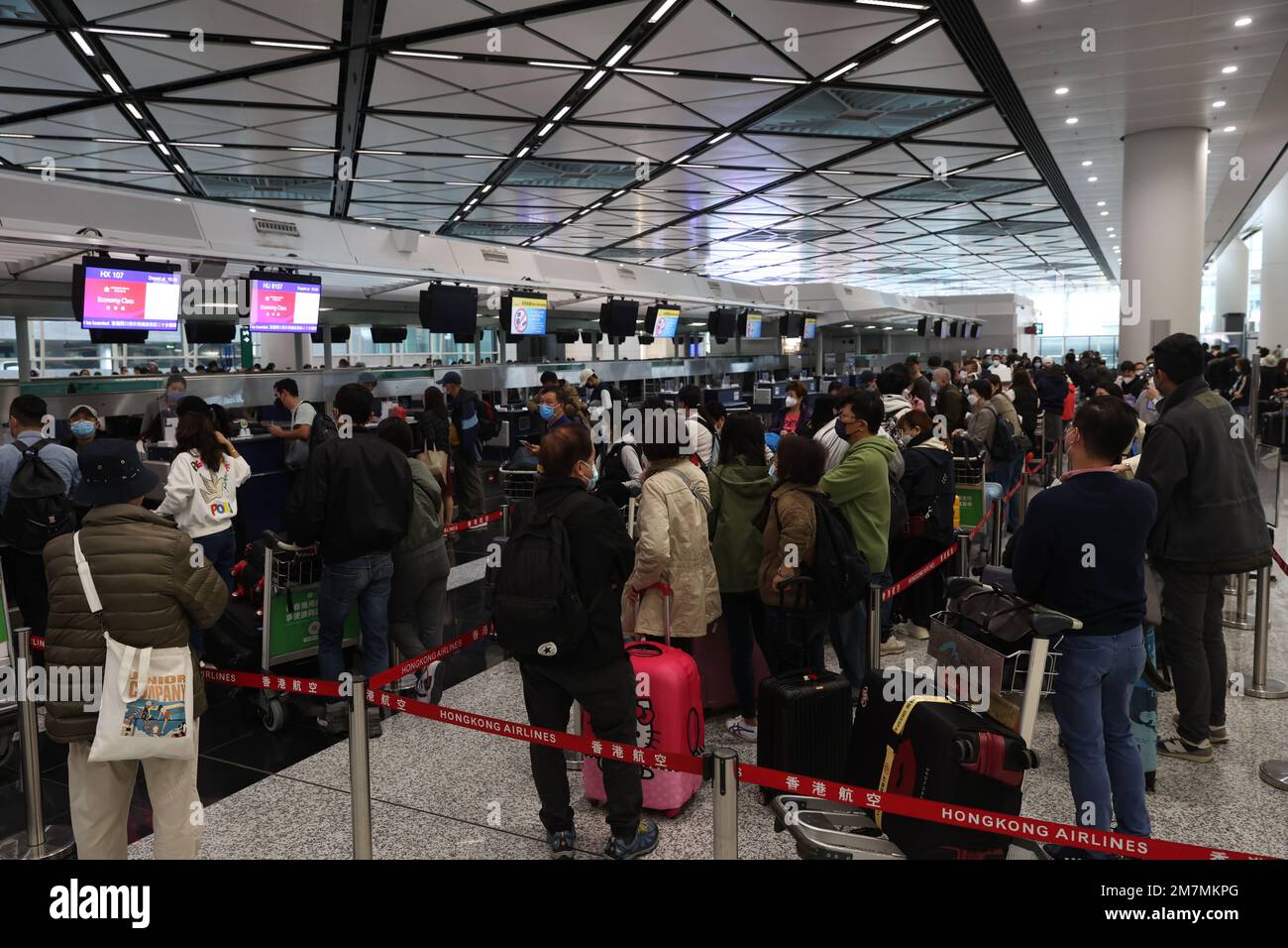 Passengers check in for their flight to mainland China at the Hong Kong ...