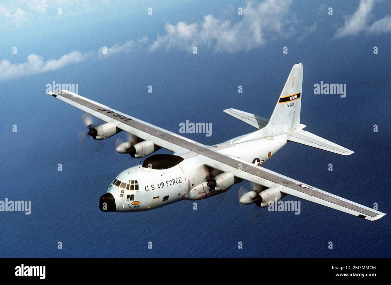An air-to-air left front view of a WC-130 Hercules aircraft from the ...