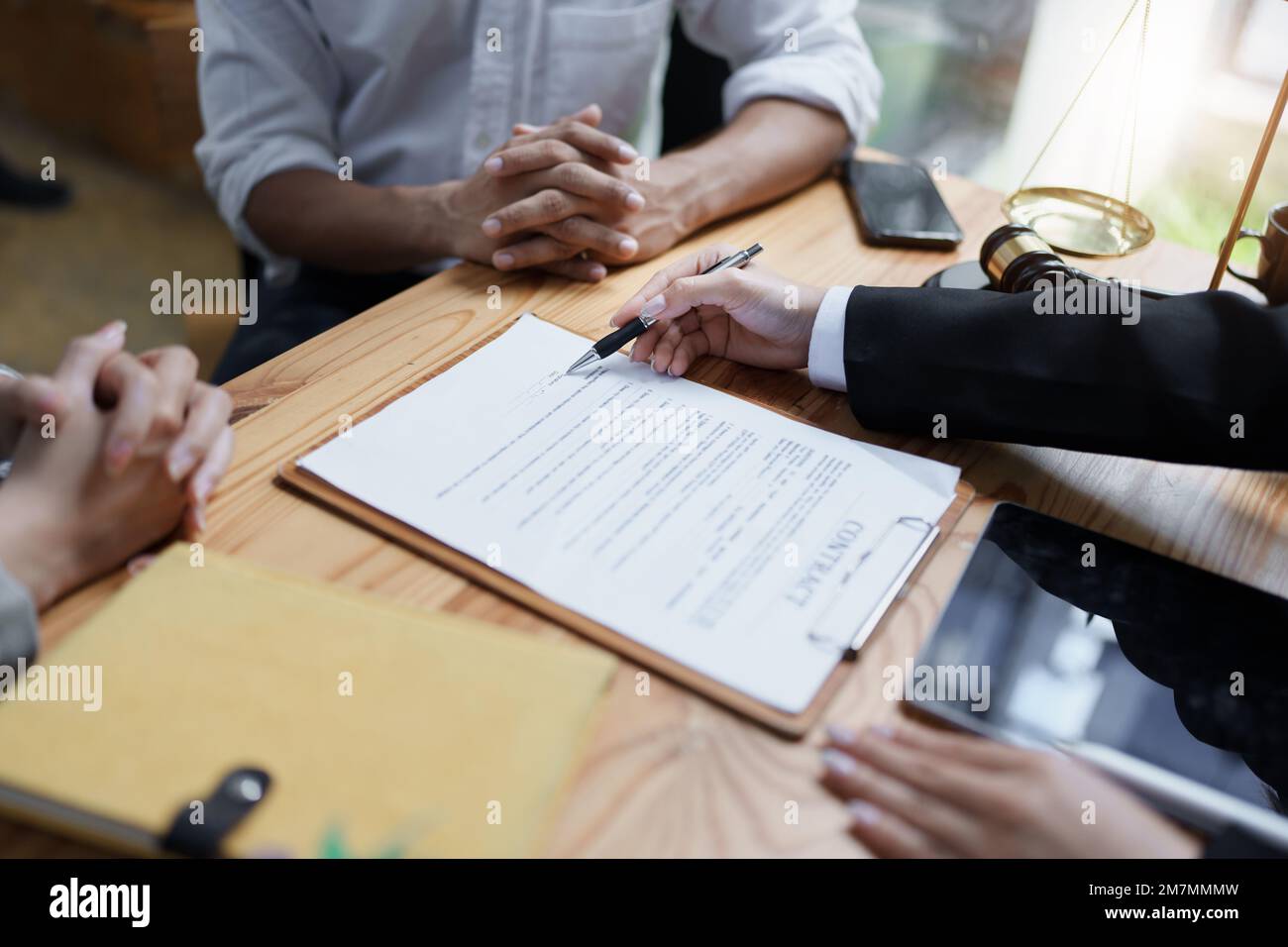 Lawyer hands important documents to couple to sign Stock Photo - Alamy