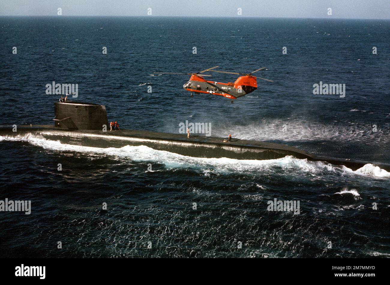 An HH-46A Sea Knight helicopter hovers over the nuclear-powered ...