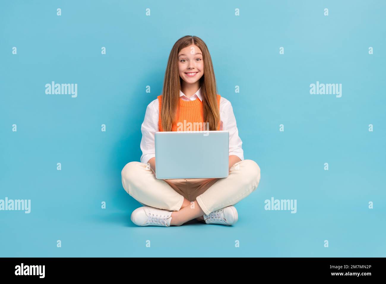 Full length photo of positive cute lady sitting floor use modern ...