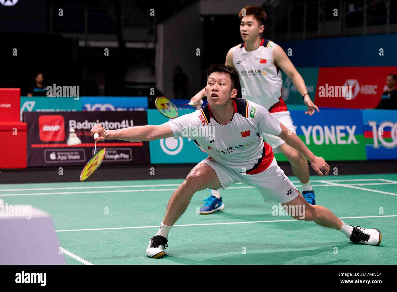 China's Ren Xiang Yu, front and Tan Qiang plays a shot against Malaysia ...