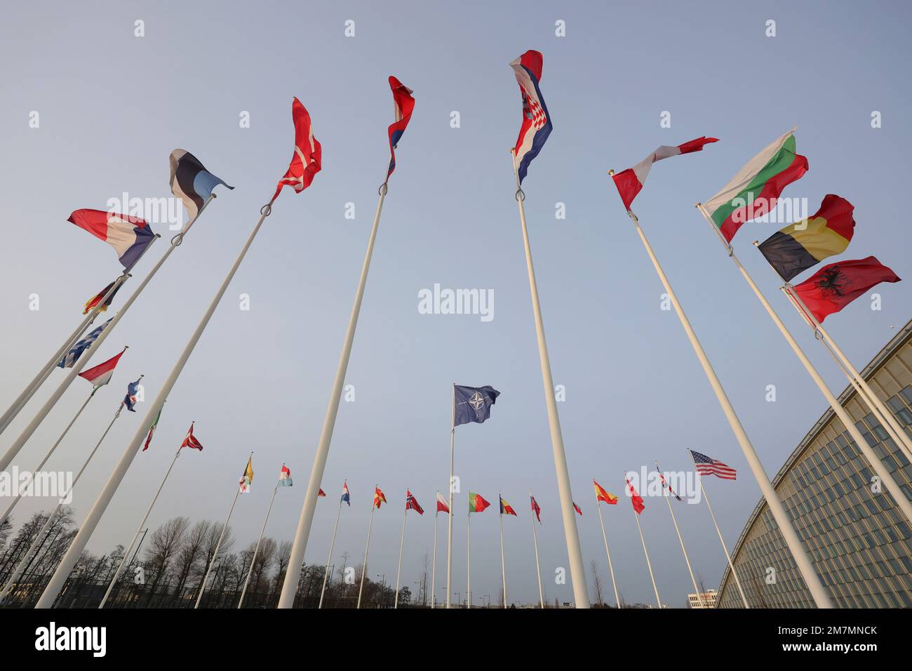 Flags of NATO members fly outside the NATO headquarters ahead of NATO ...