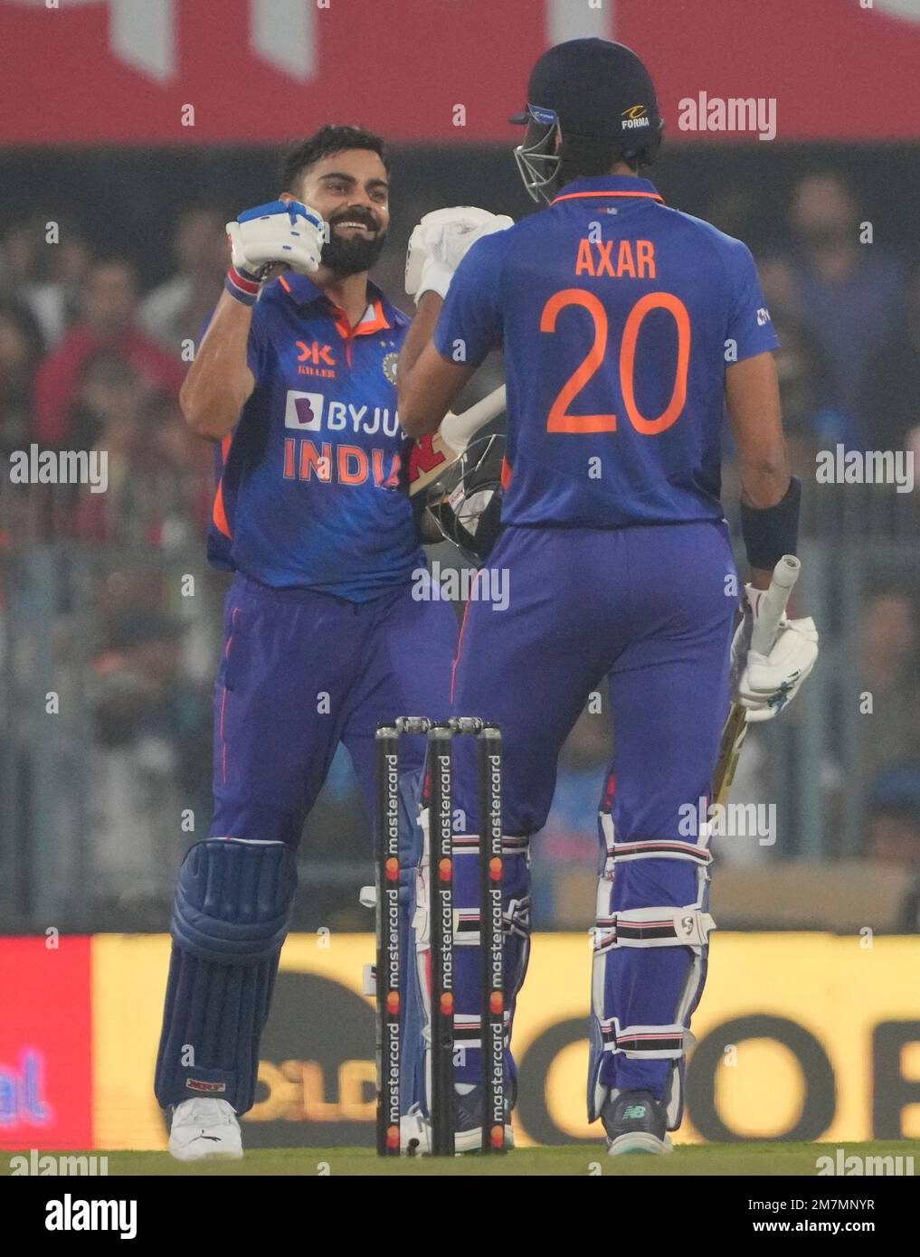 India's Virat Kohli, left, celebrates scoring a century with Axar Patel ...