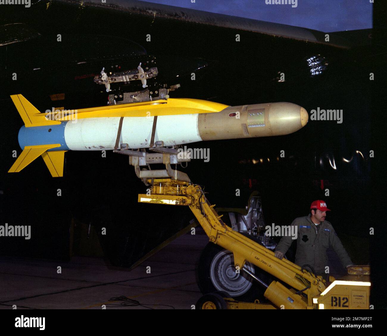 A GBU-15 (PW) is hoisted up under the wing of a B-52 Stratofortress ...