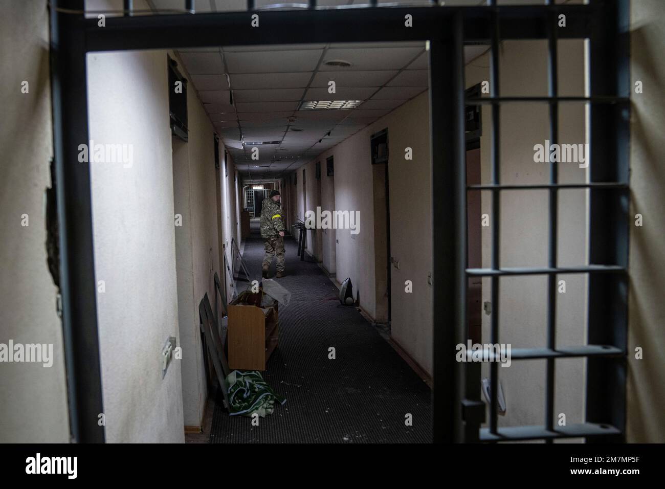 A Ukrainian serviceman walks in the corridor of a basement in a ...