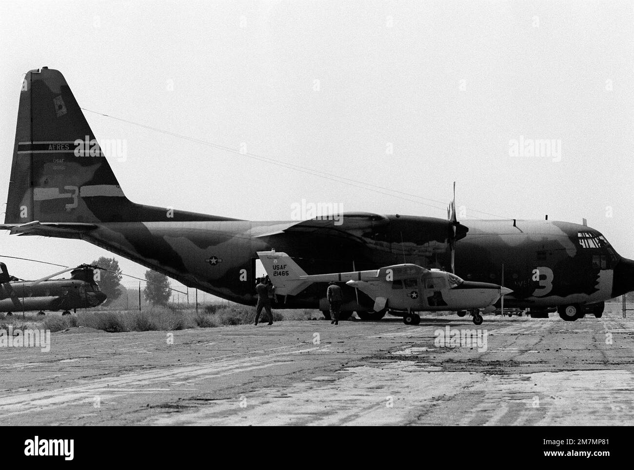 A right side view of Air Force Reserve C-130 Hercules aircraft and a ...