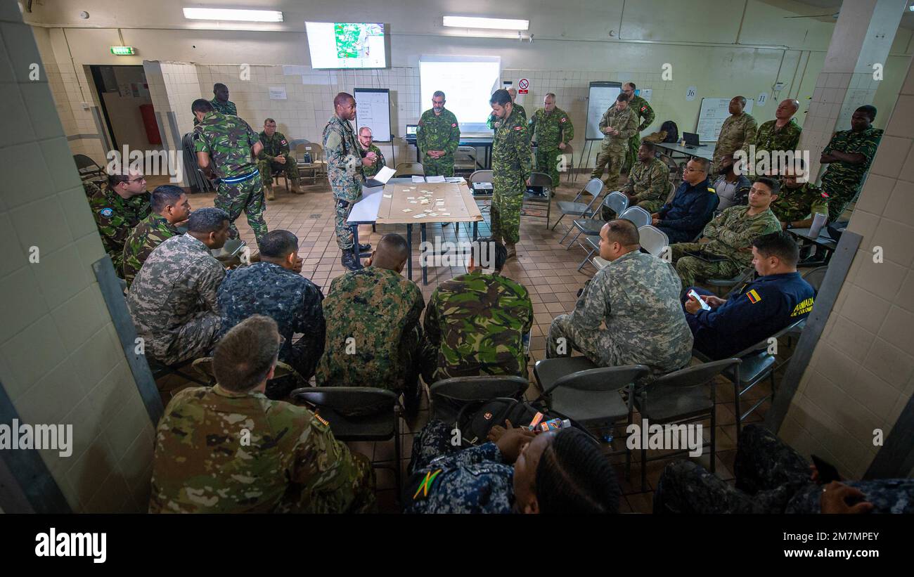Major Webster Williams (Jamaica Defence Force, left of table) provides ...