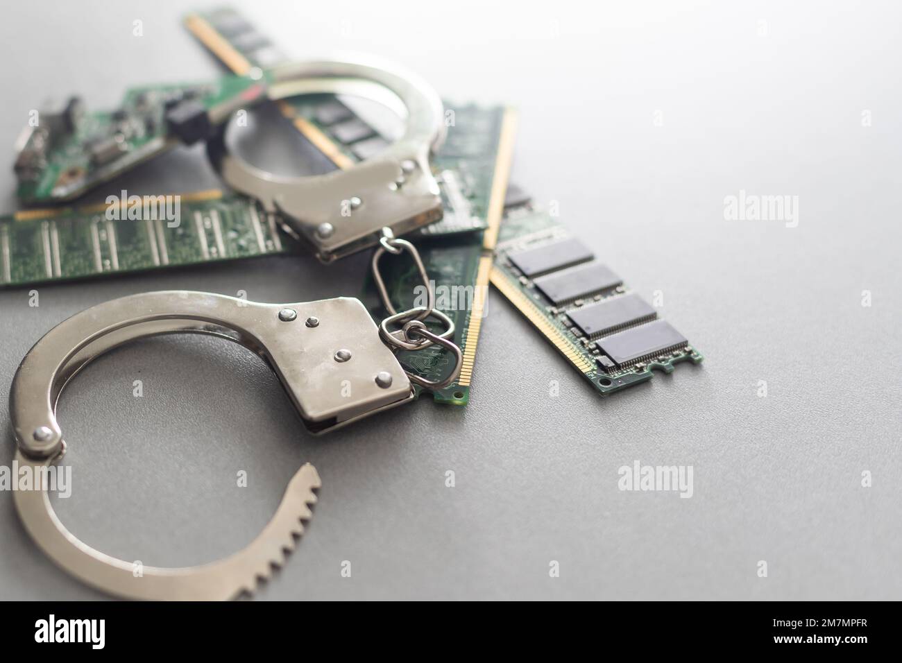 handcuffs against a computer electronics board. The concept of ...