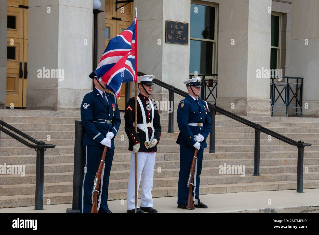 The honor cordon stand at attention as Secretary of Defense Lloyd J ...