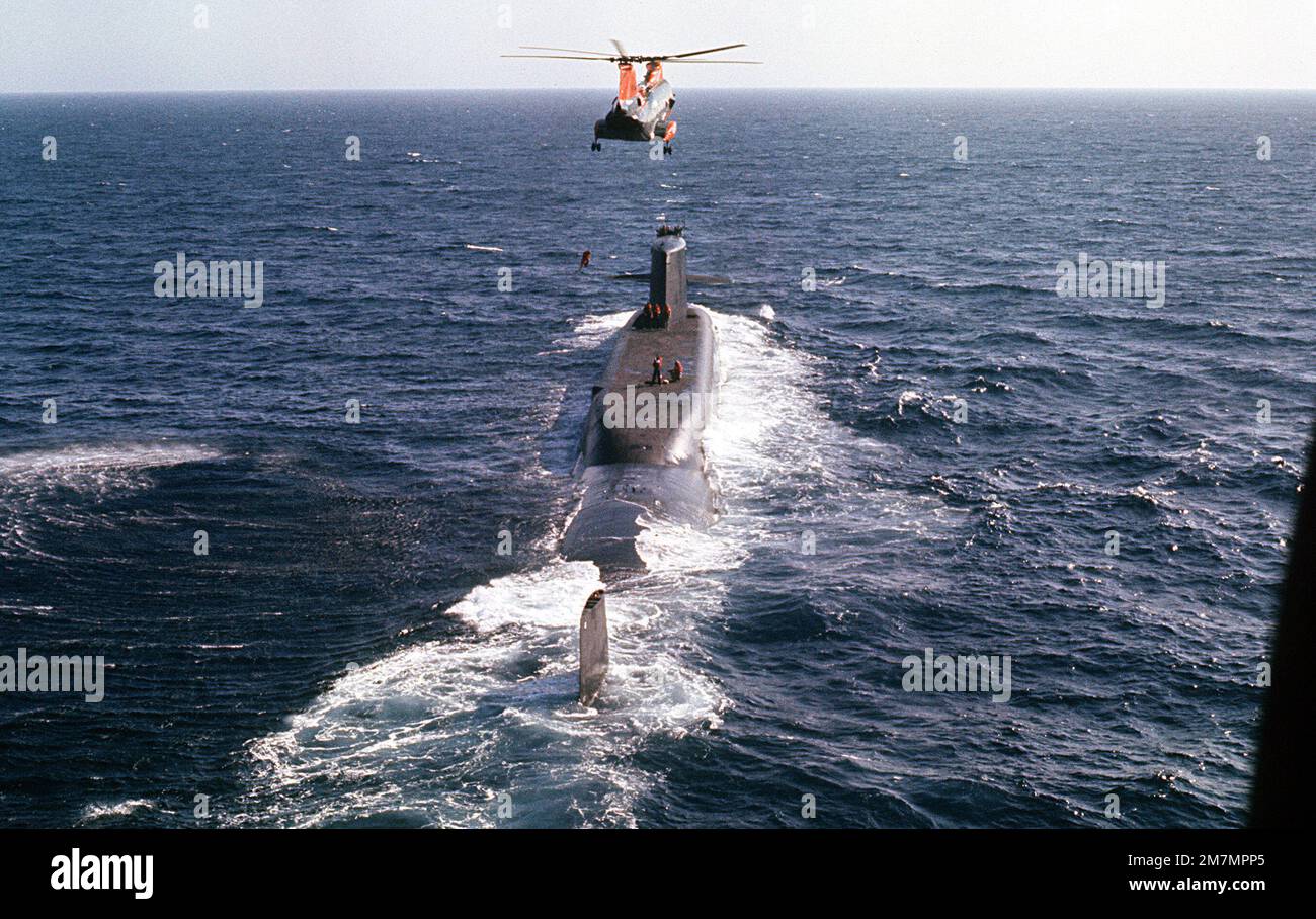 An HH-46A Sea Knight helicopter hovers over the nuclear-powered ...