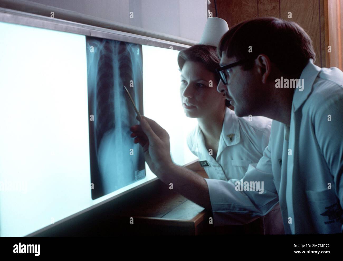 A U.S. Army doctor and nurse examine an X-ray. Country: Unknown Stock ...