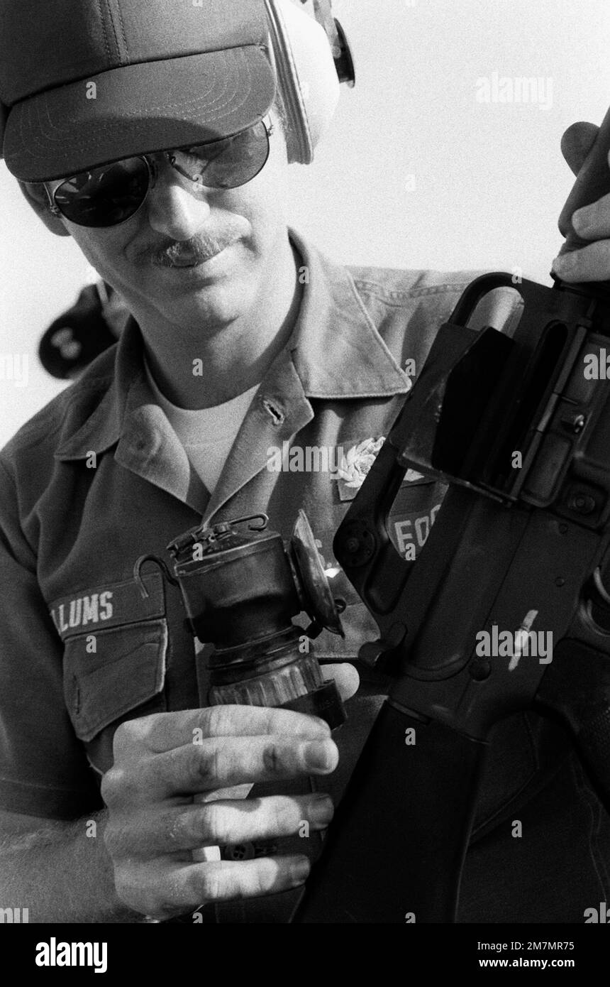 SGT Curtis B. Allums blackens the sight on his M-16 rifle before firing ...