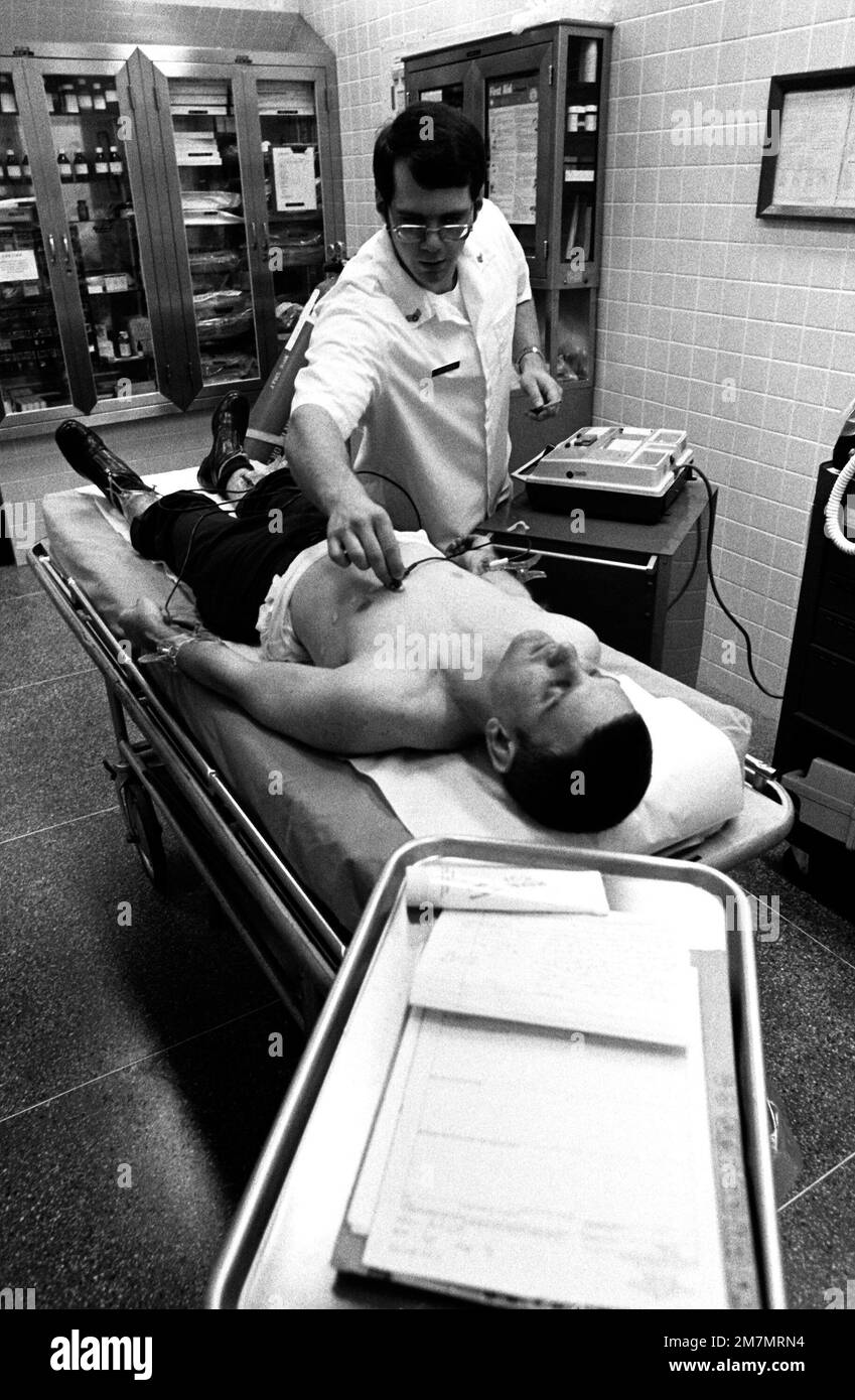 SENIOR AIRMAN Harry Jeffries connects an EKG (electro-cardiograph) wire ...