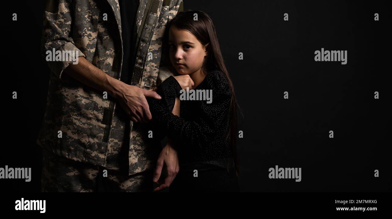 Masculine sad military man hugging her upset daughter indoors Stock ...