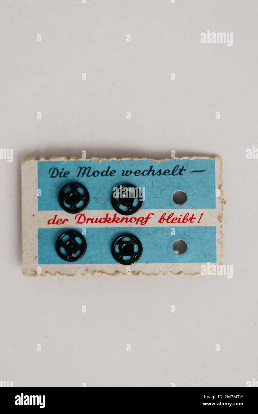 Black snap fasteners on a piece of cardboard Stock Photo - Alamy