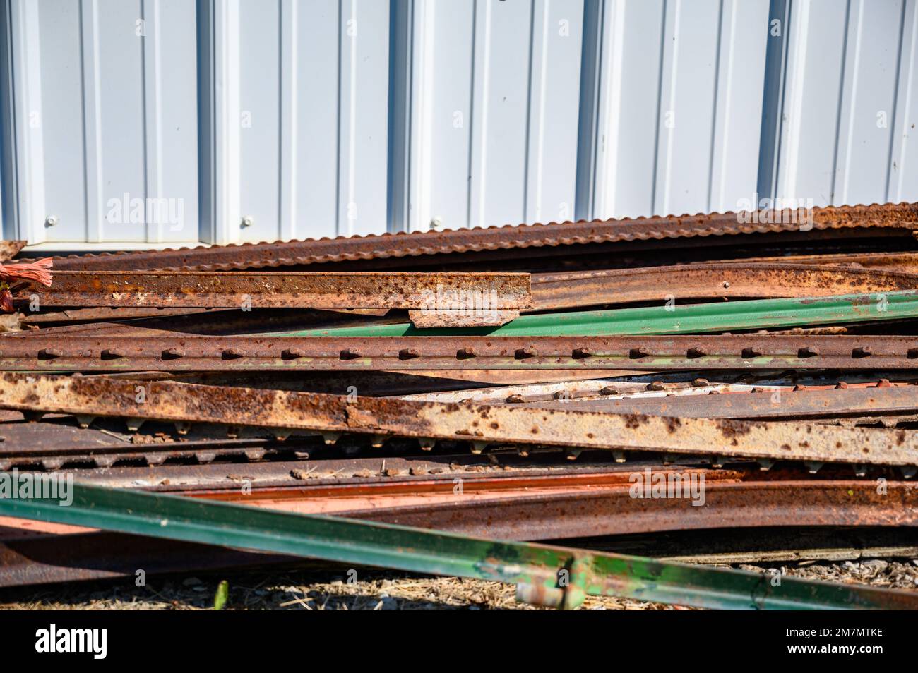 Pile of rusted steel fence posts on the ground Stock Photo - Alamy