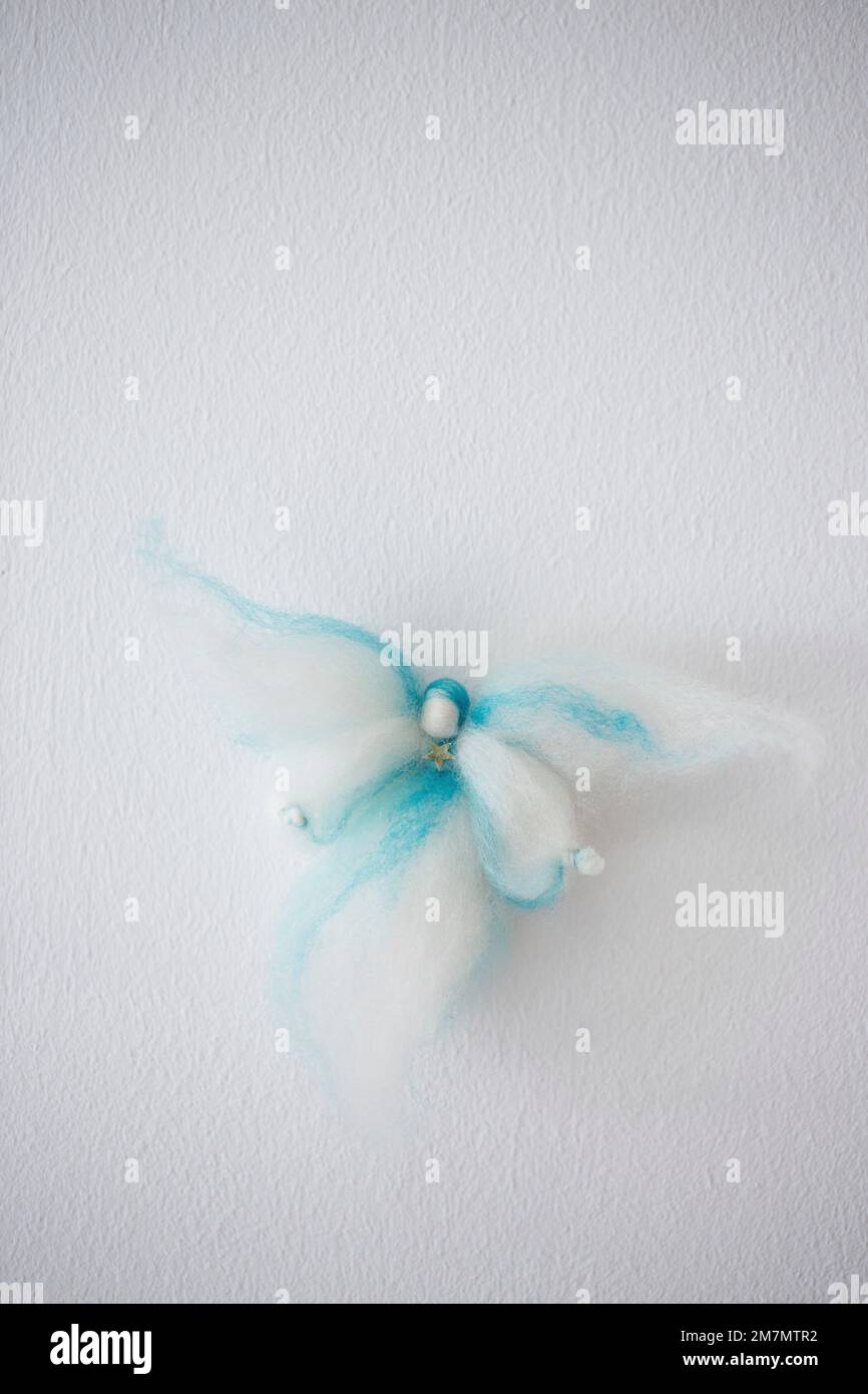 Small homemade wool angel on white background Stock Photo - Alamy