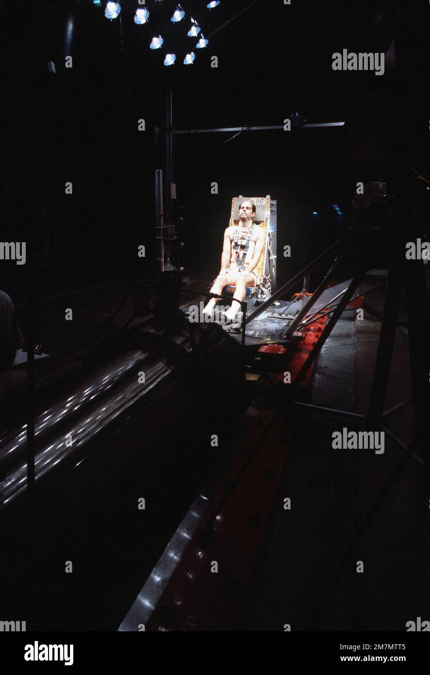 A pilot is prepared to take a sled-run test for high-speed survival by ...